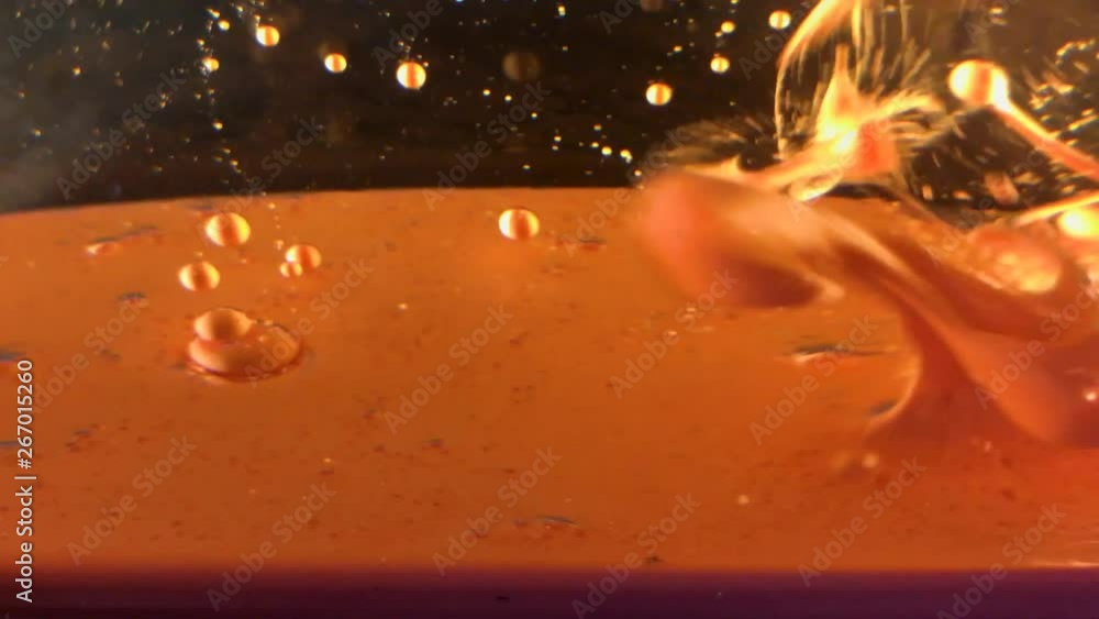 4K Stirring oil and color fast loops and swooshes with bubble and ...