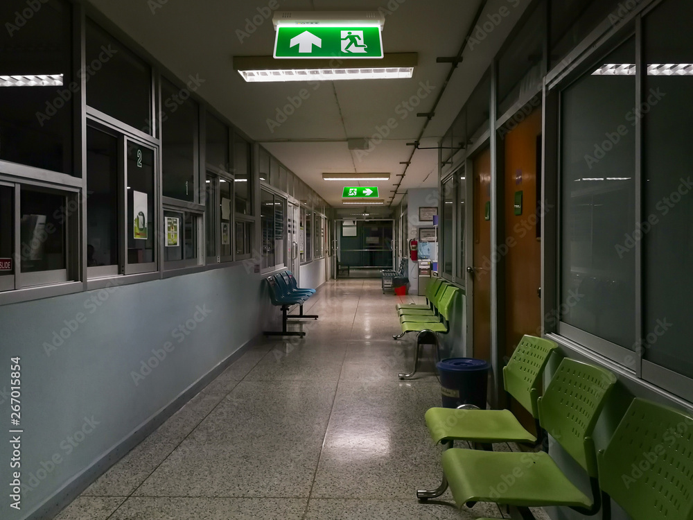 Green emergency exit sign in hospital showing the way to escape at ...