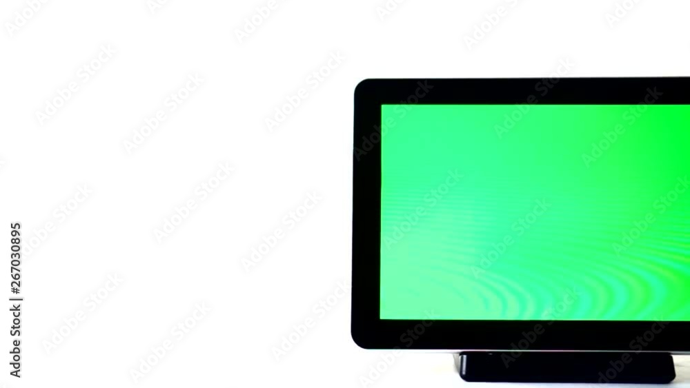 Dolly right to tablet on stand with green screenTablet on a stand with ...