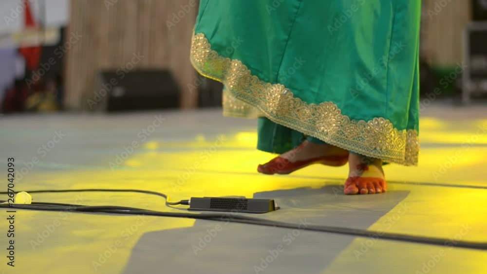 Shot of dancing feet of female Indian classical Kathak dancer decorated ...