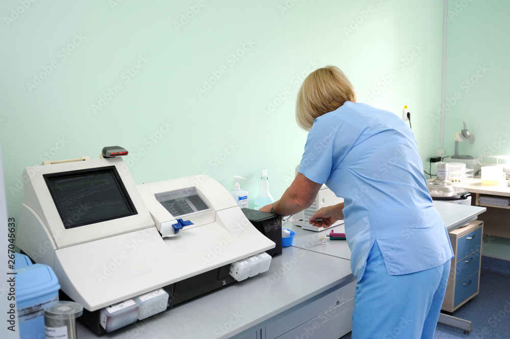 At a hospital laboratory. Lab technician performing analysis of blood ...