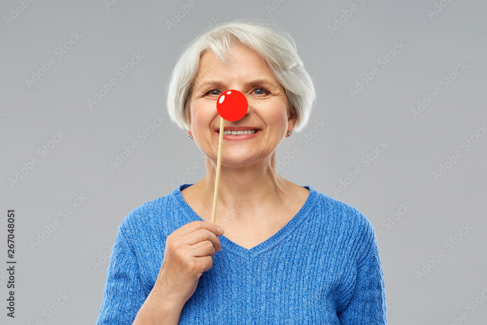 red nose day, party props and photo booth concept - portrait of smiling ...