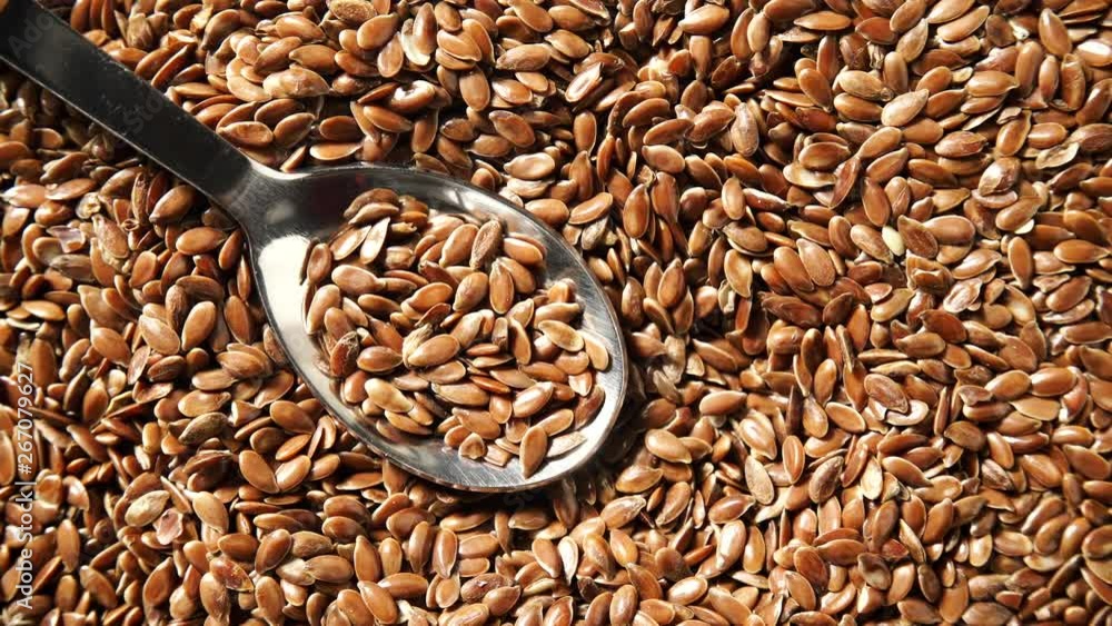Brown raw flax seeds linseed as natural food background or grain texture. Flaxseeds full of ...