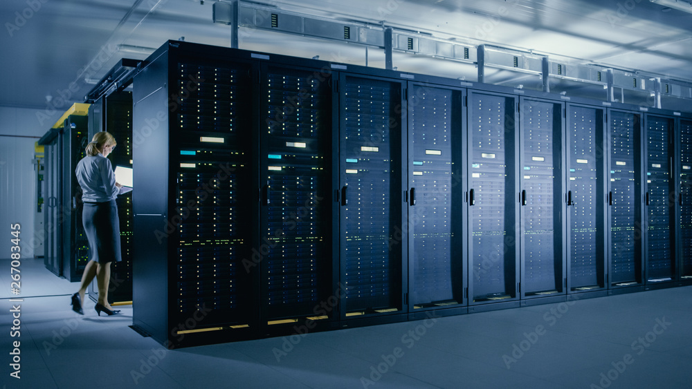 In Data Center: Female IT Technician Walks Between Rows of Server Racks ...