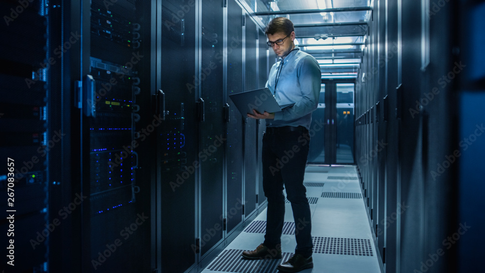 In Data Center IT Engineer Stands Before Working Server Rack Doing ...
