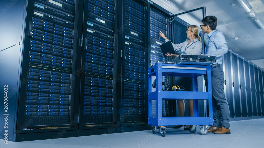 In the Modern Data Center: Engineer and IT Specialist Work with Server ...