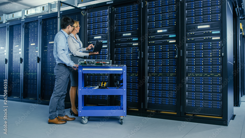 In the Modern Data Center: Engineer and IT Specialist Work with Server ...
