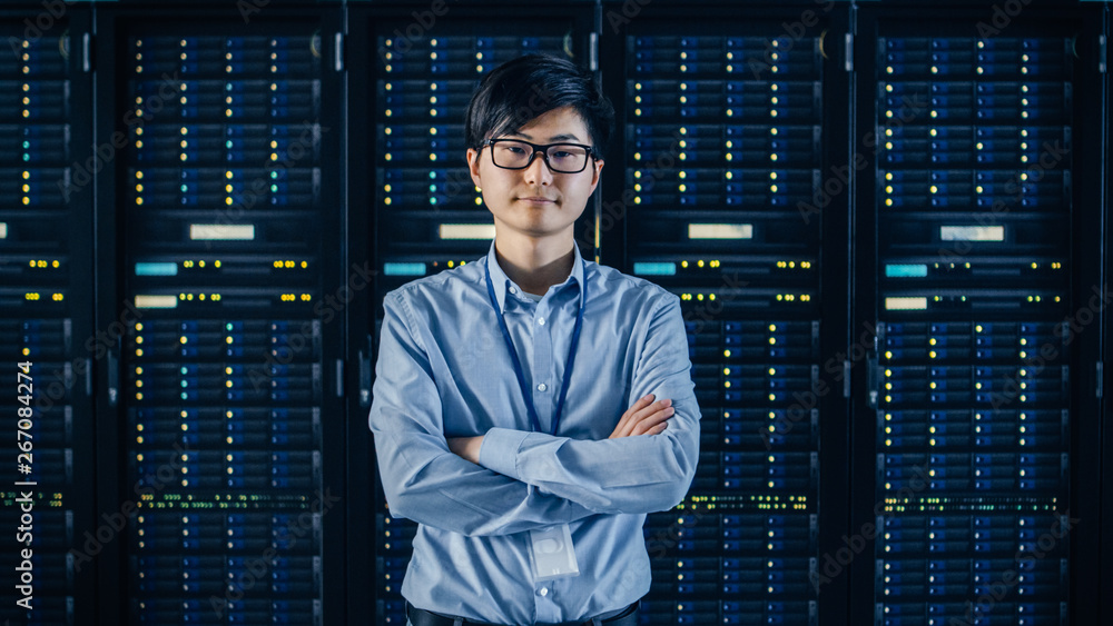 In the Modern Data Center: Portrait of IT Engineer Standing with Server ...