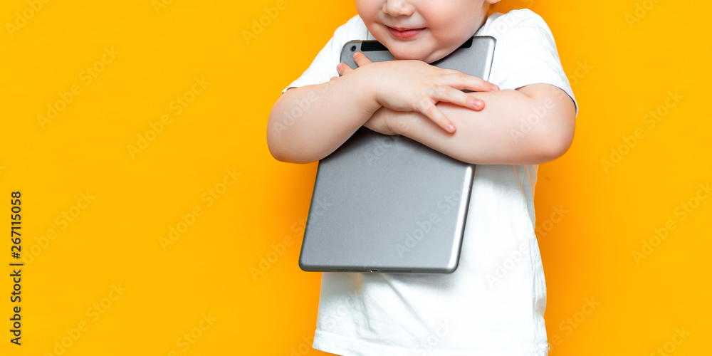 happy cute boy hugging his lovely tablet computer pc, Z generation ...