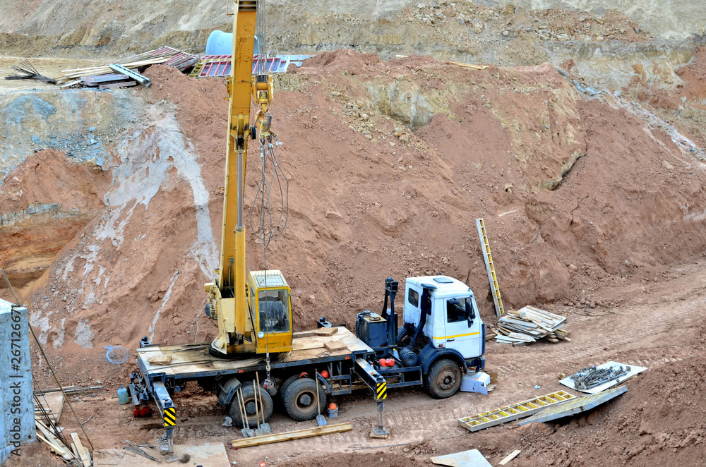 Crane operation in the pit, laying or replacement of underground storm ...