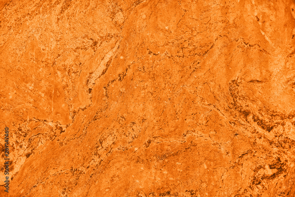 Close up of abstract turmeric orange toned granite stone texture with ...