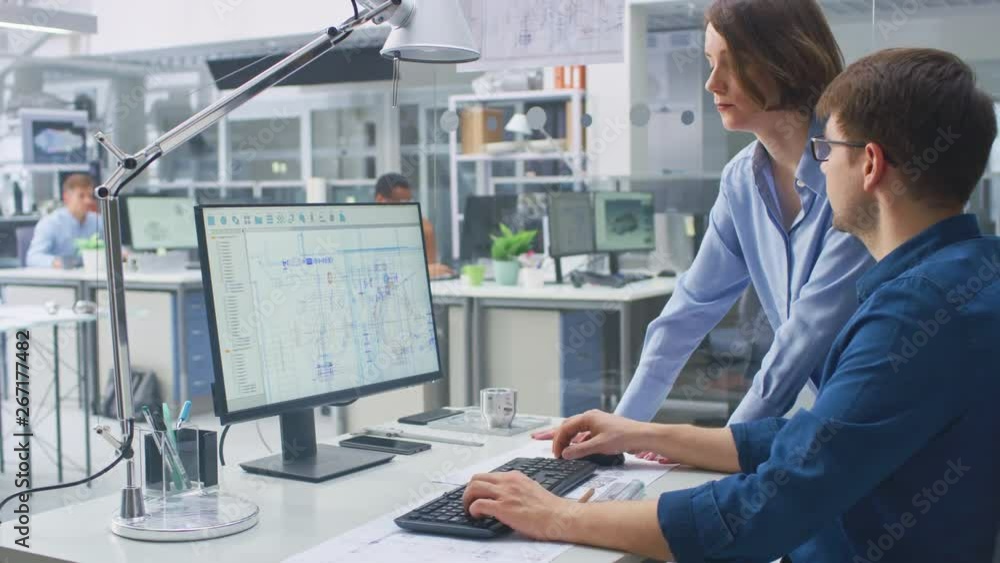 Engineer Talking With Project Manager and Working on Desktop Computer Using CAD Software with ...