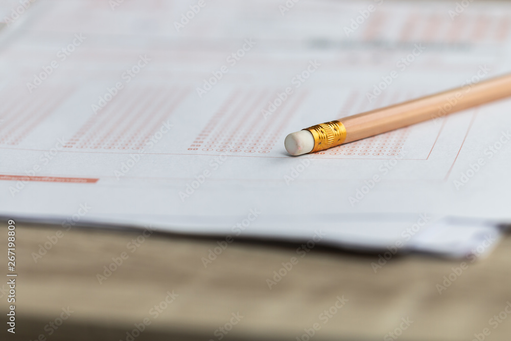 Pencil eraser on standardized test exam multiple carbon paper form with ...