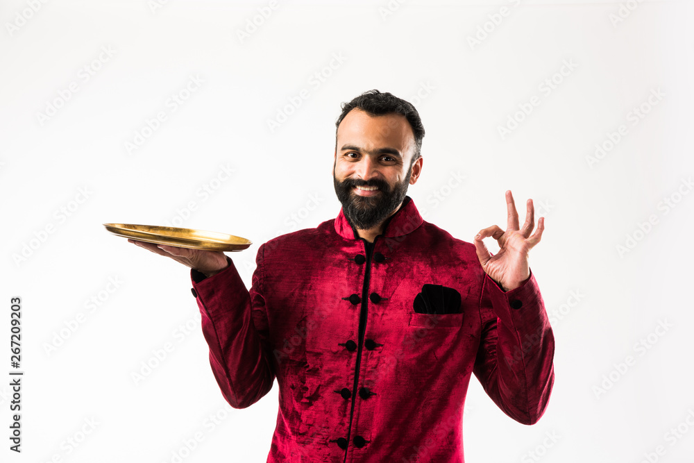 Indian Man holding empty plate while wearing traditional Sherwani on ...