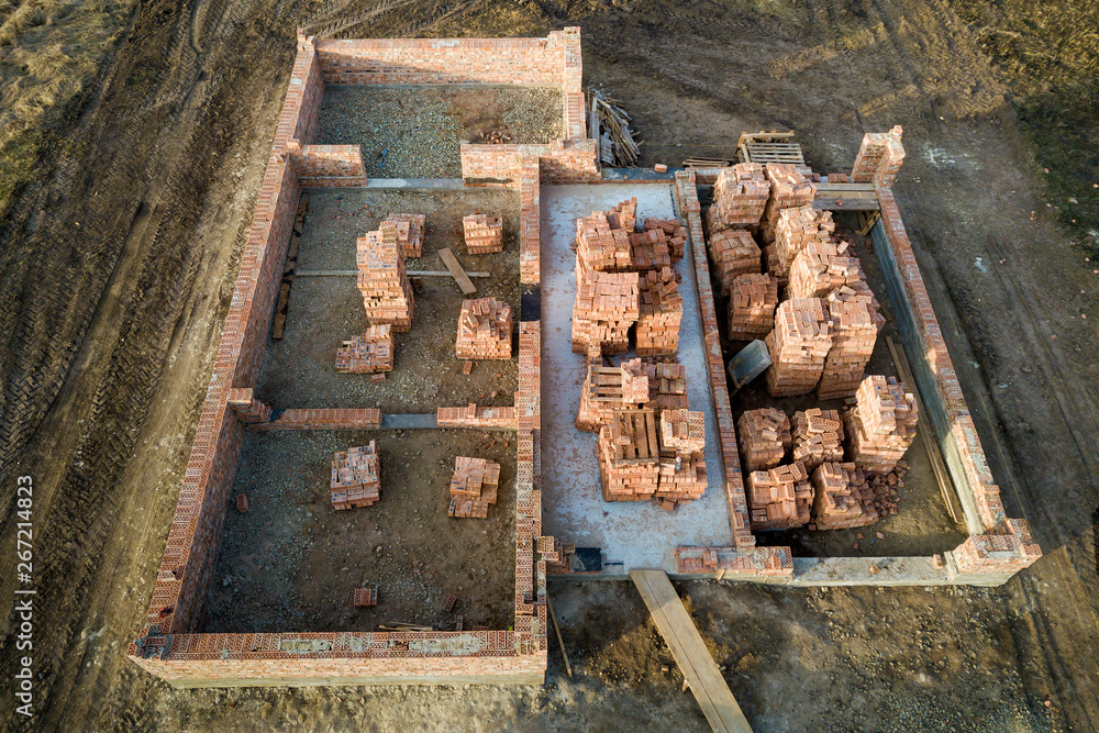 Aerial view of building site. Trenches dug in ground and filled with ...
