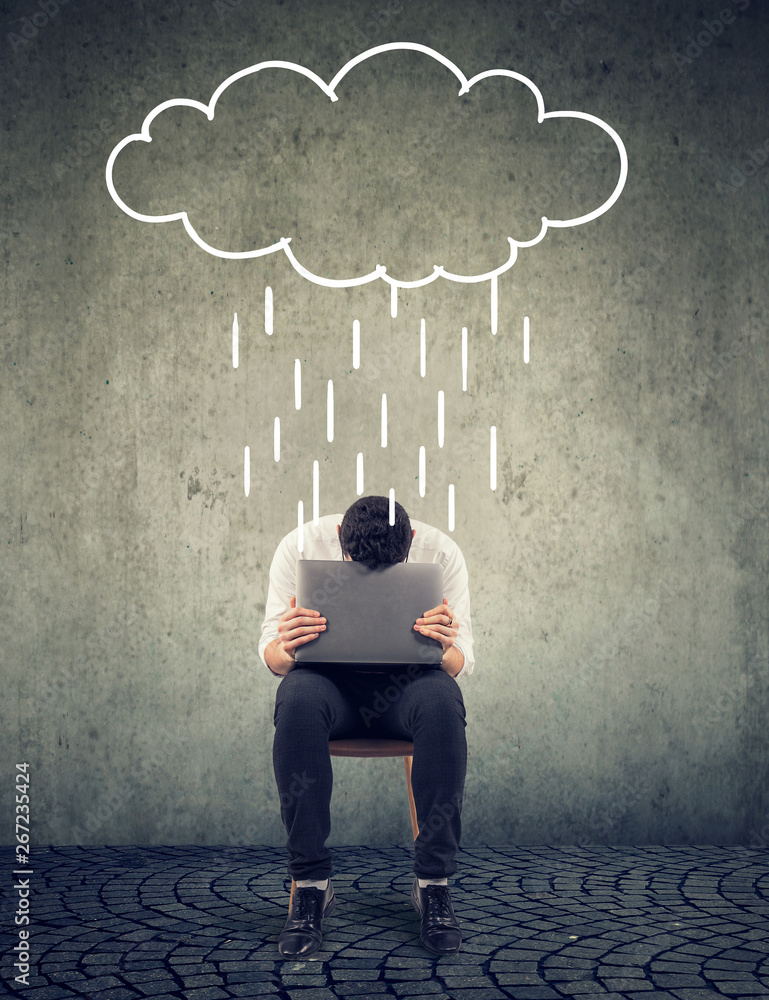 Sad business man sitting on a chair with laptop looking down with a rain cloud above Stock Photo ...