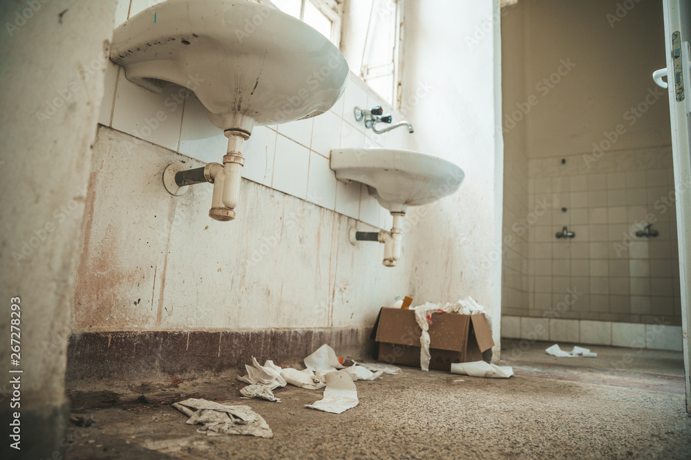 old dirty toilet in abandoned psychiatric hospital building. dirt and ...