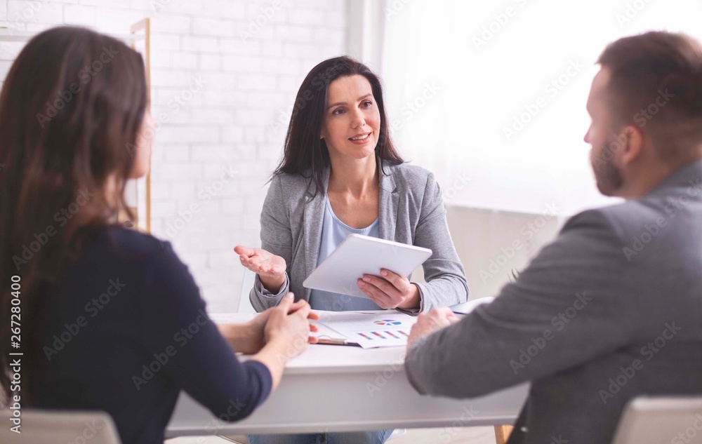 Professional woman talking to young couple at personal meeting Stock ...