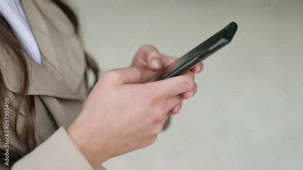 Close up shot of Caucasian young female hands texting on phone. Side ...