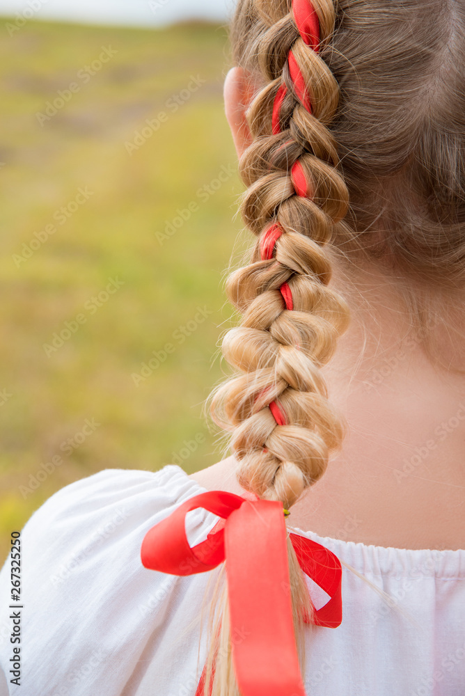 Russian girl Slavic appearance with braids with red ribbons in the ...