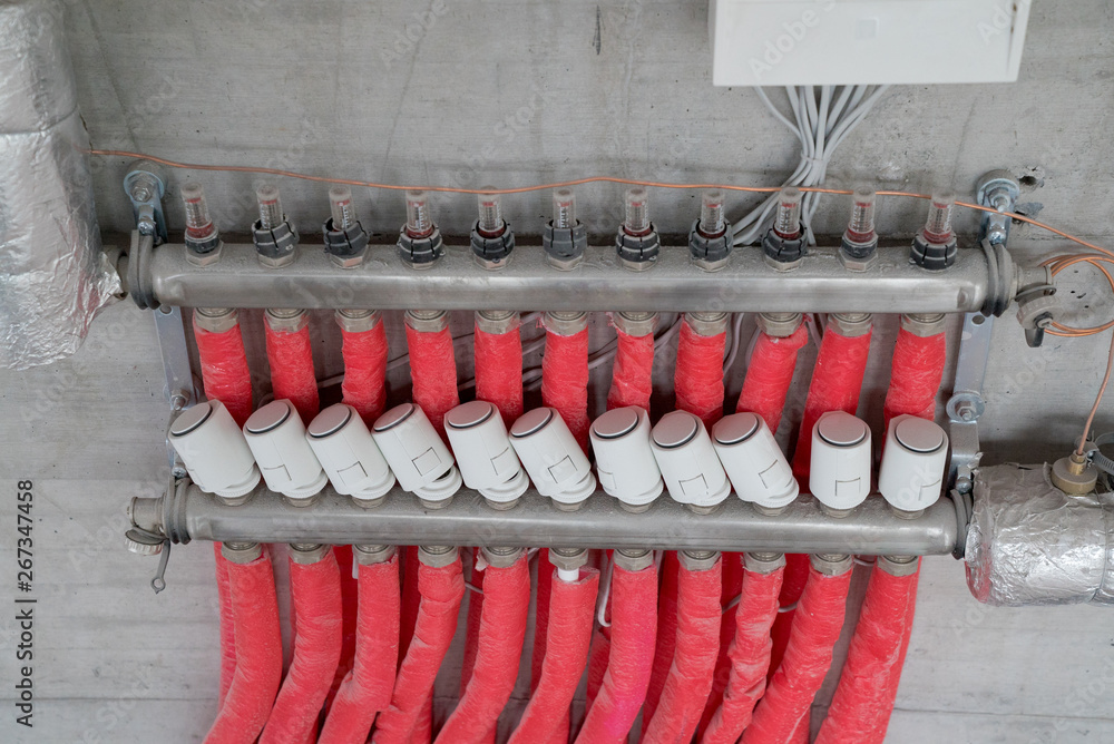 red floor heating pipes and valves at the regulation mains Stock Photo ...
