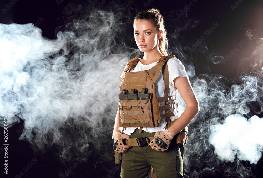 Portrait beautiful blonde female soldier dressed in plate carrier and ...
