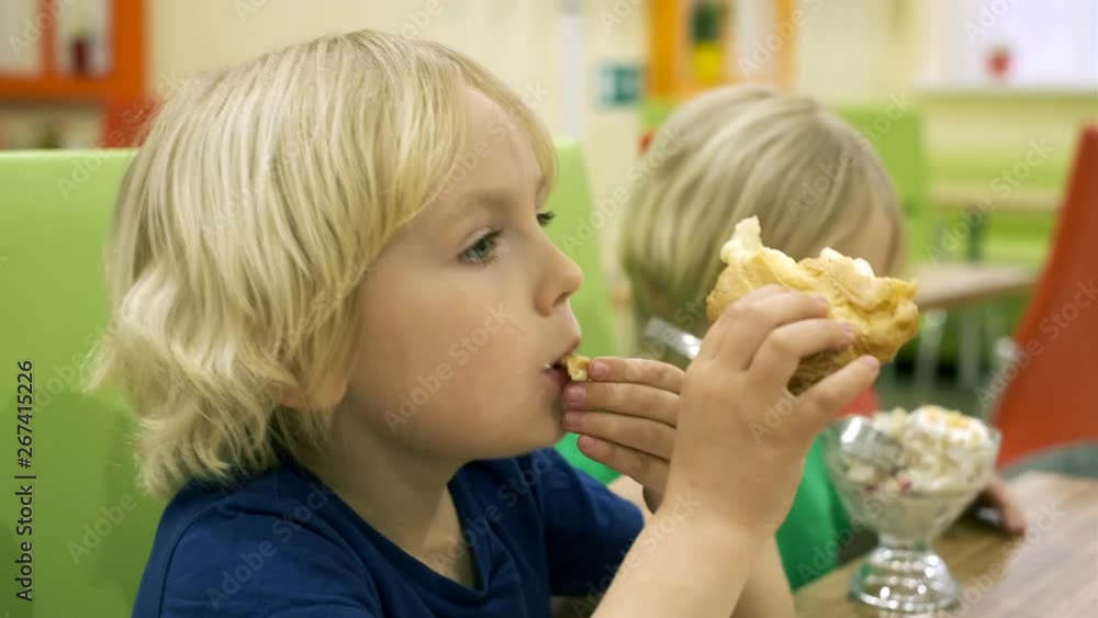 Boys brothers eat lunch at the kitchen Stock ビデオ | Adobe Stock