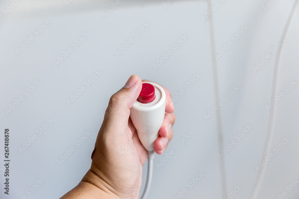 hand pushing nurse call button . patient press red emergency button to ...