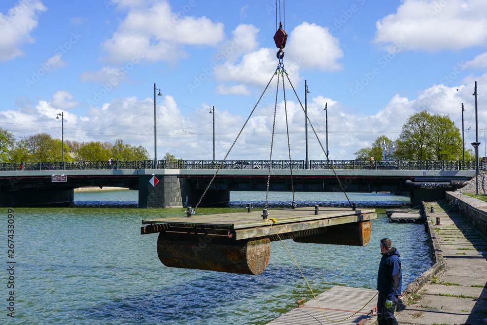 Placing a floating marina pontoon in the water with the help of a crane ...