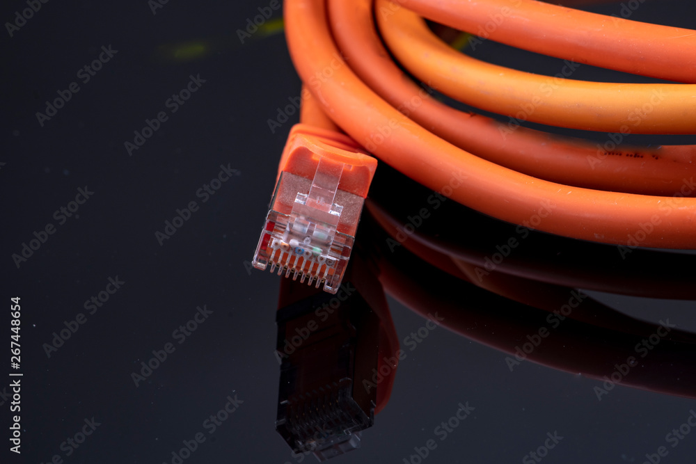 orange data cable for fast internet on black background for a modern ...