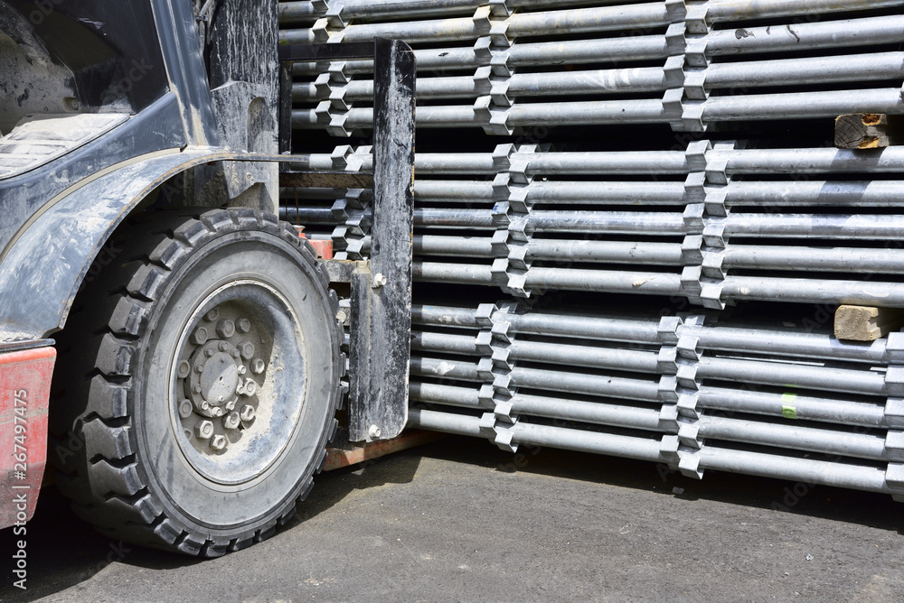 Scaffolding Material Yard :Loading a scaffolding pillars with a ...