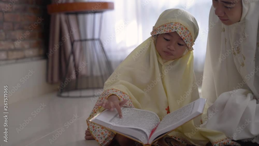 muslim parent and daughter reading quran after praying together Stock ...