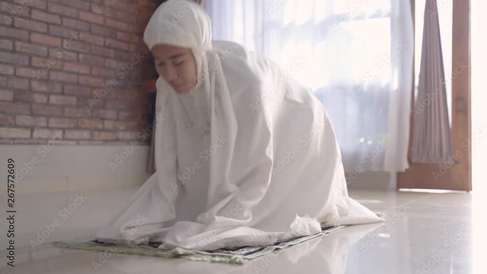 muslim woman sujud. asian woman praying or solat in islam prostration ...