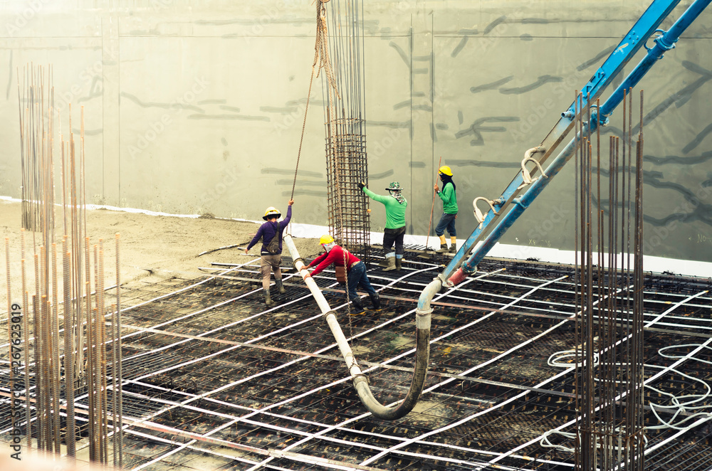 Construction Worker Concrete Pouring During Commercial Concreting
