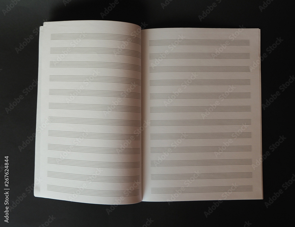 Blank music sheet book for writing notes isolated on black background ...