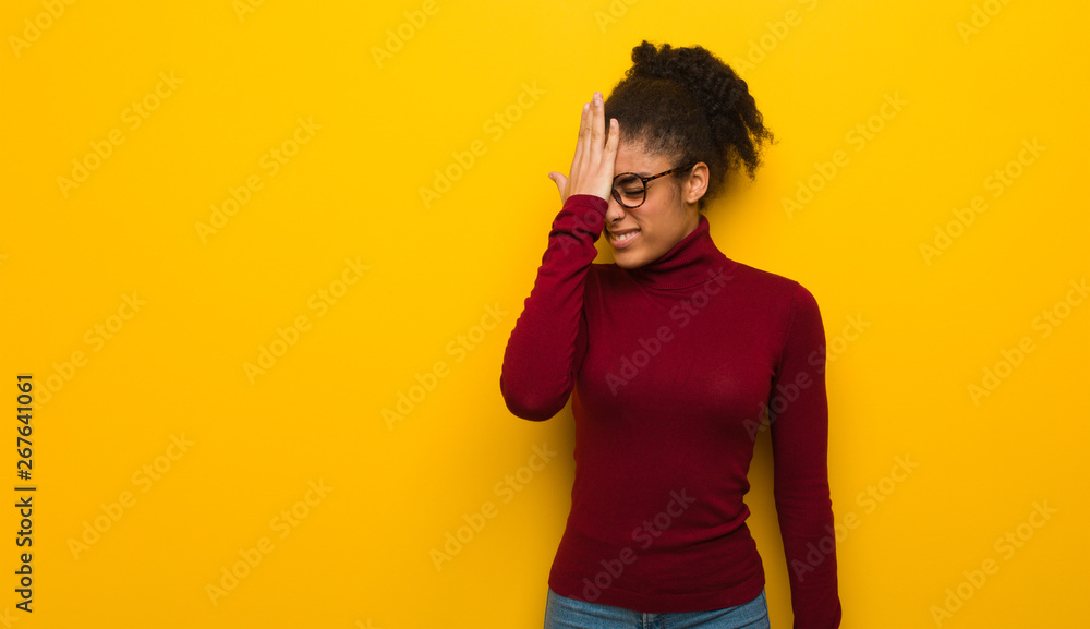 Young black african american girl with blue eyes forgetful, realize ...
