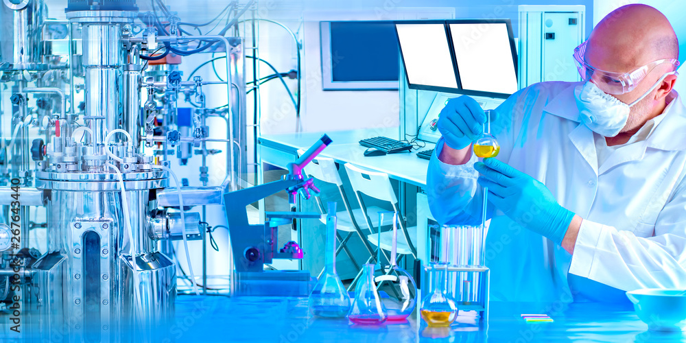 Microbiology laboratory. Male chemist checks the density of the ...