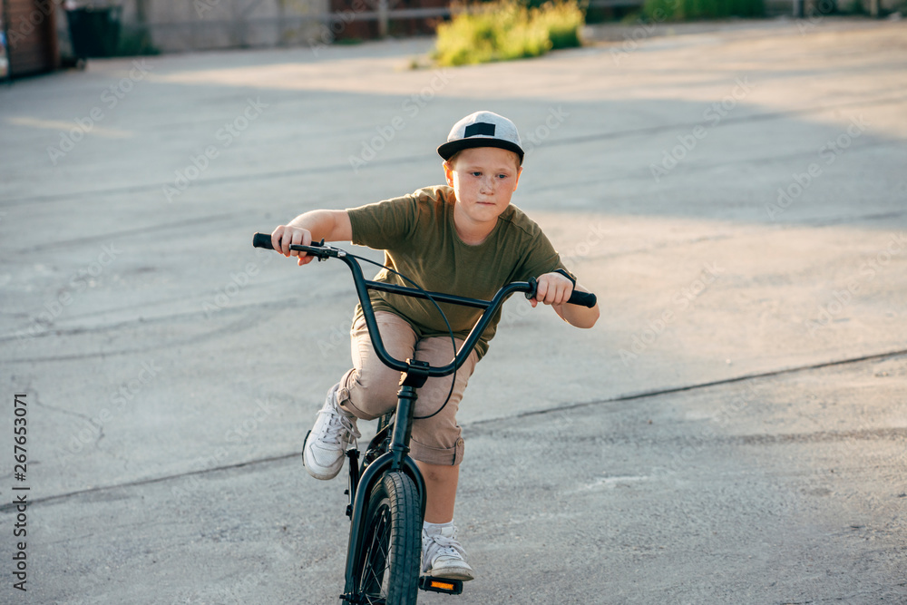 Boy riding BMX bike Stock Photo | Adobe Stock