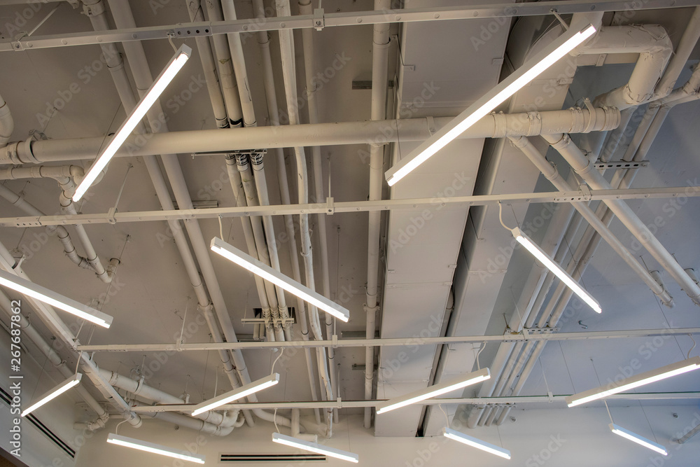 A unique display of lighting in the ceiling of a industrial building ...