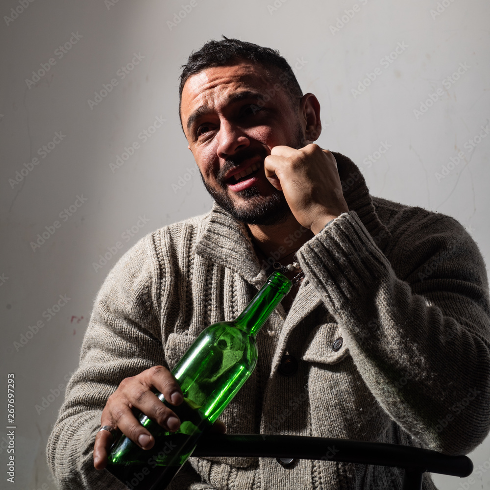 He is binge drinking. Hispanic man suffering from unhealthy alcohol ...