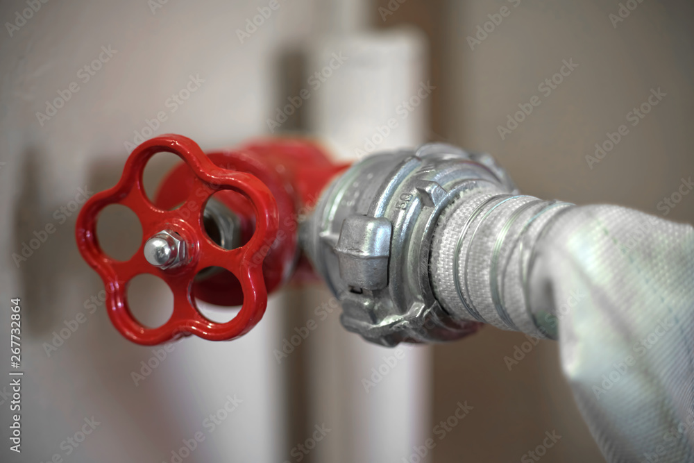 Connection of a fire hose with a red fire cock, close-up Stock Photo ...