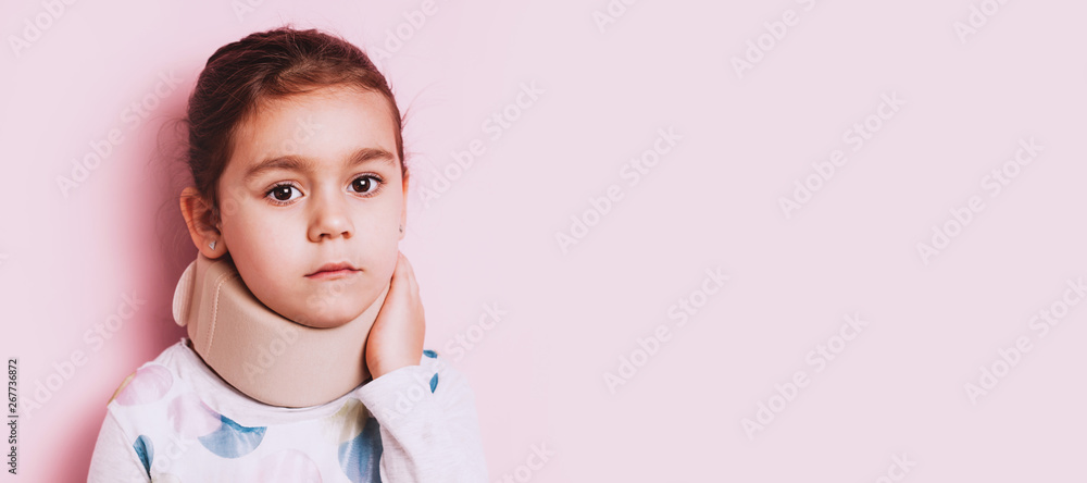 Portrait of screaming Little girl wearing neck brace on pink background ...