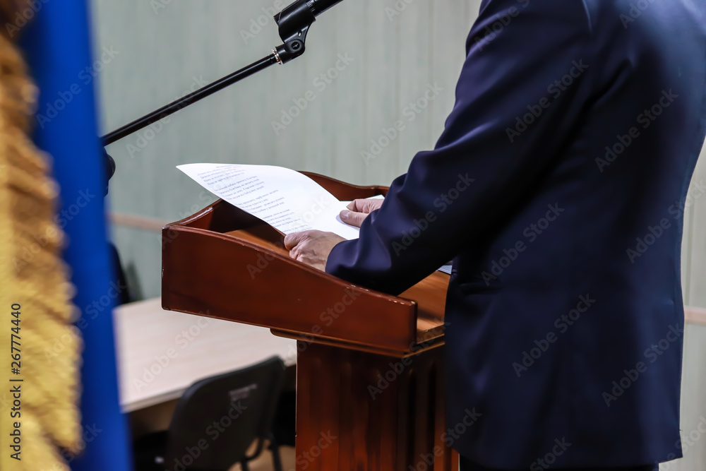 speaker behind the podium Stock Photo | Adobe Stock