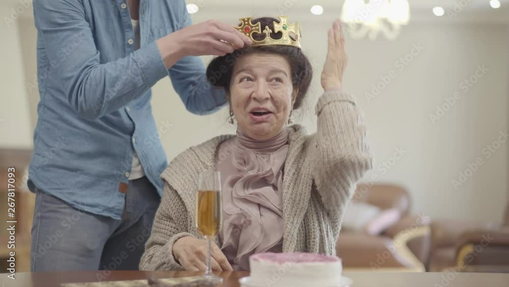 Vídeo do Stock: Portrait of beautiful old woman. Adult grandson brings ...