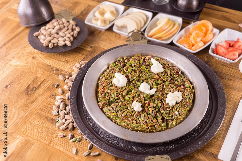 turkish dessert kunefe, kunafa, kadayif with pistachio powder and ...