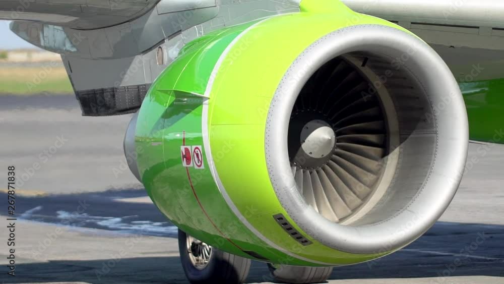 Jet turbine engine of aircraft on runway in airport. Working jet engine ...