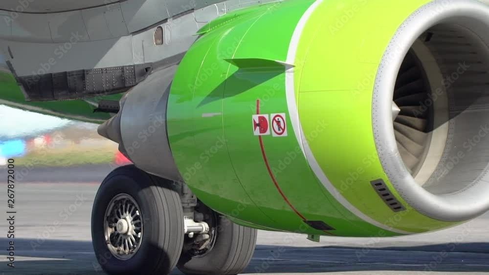 Jet turbine engine of aircraft on runway in airport. Working jet engine ...
