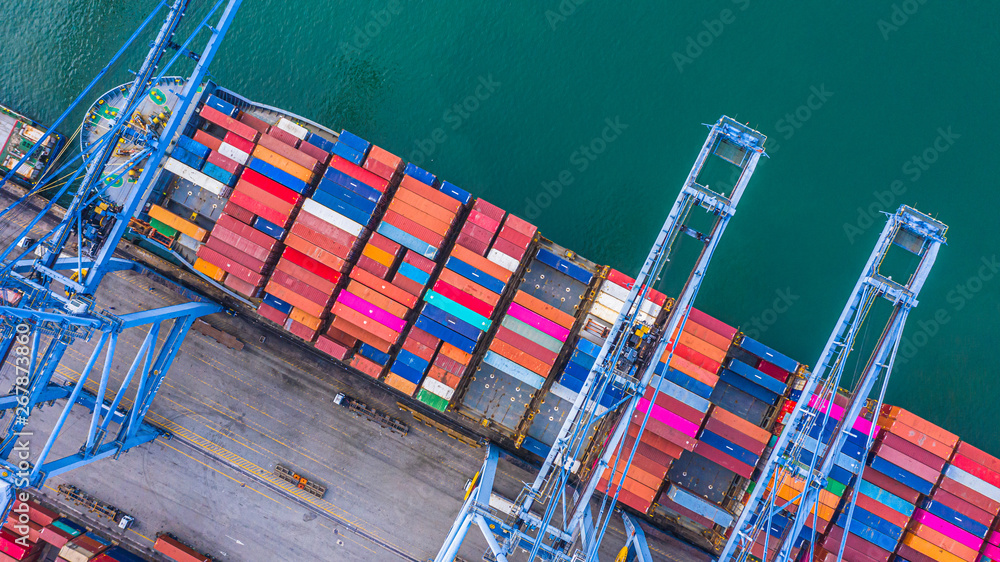 Container ship loading and unloading in deep sea port, Aerial top view of logistic import export ...