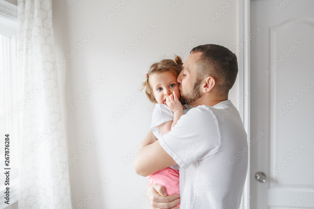 Caucasian father hugging and kissing toddler baby girl. Parent hugging ...