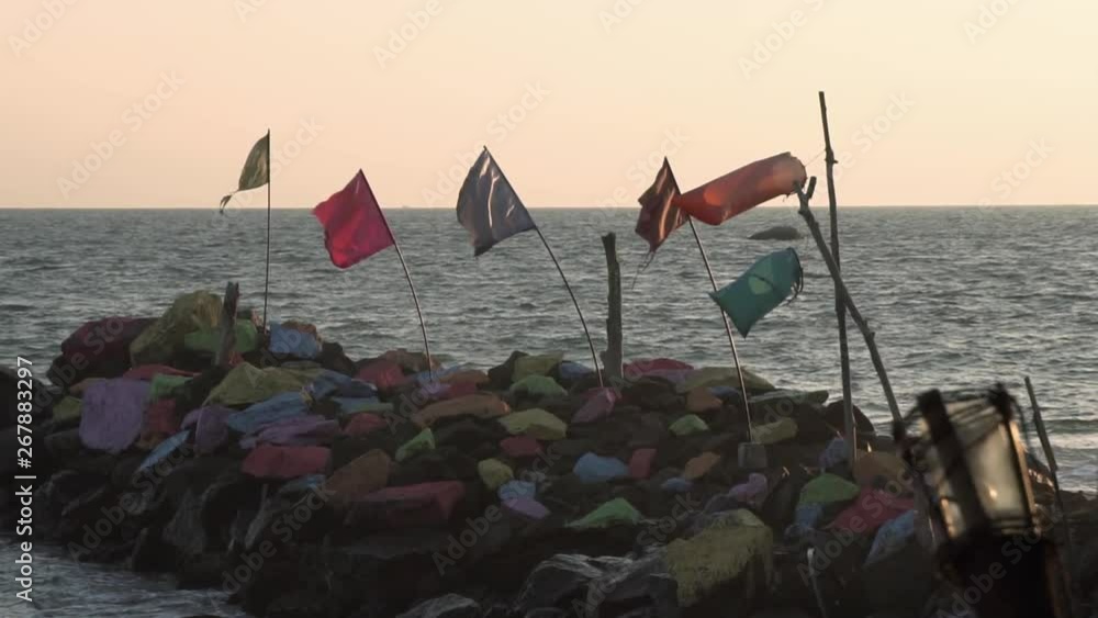Slow motion static scene looking at colourful pile of painted rocks ...